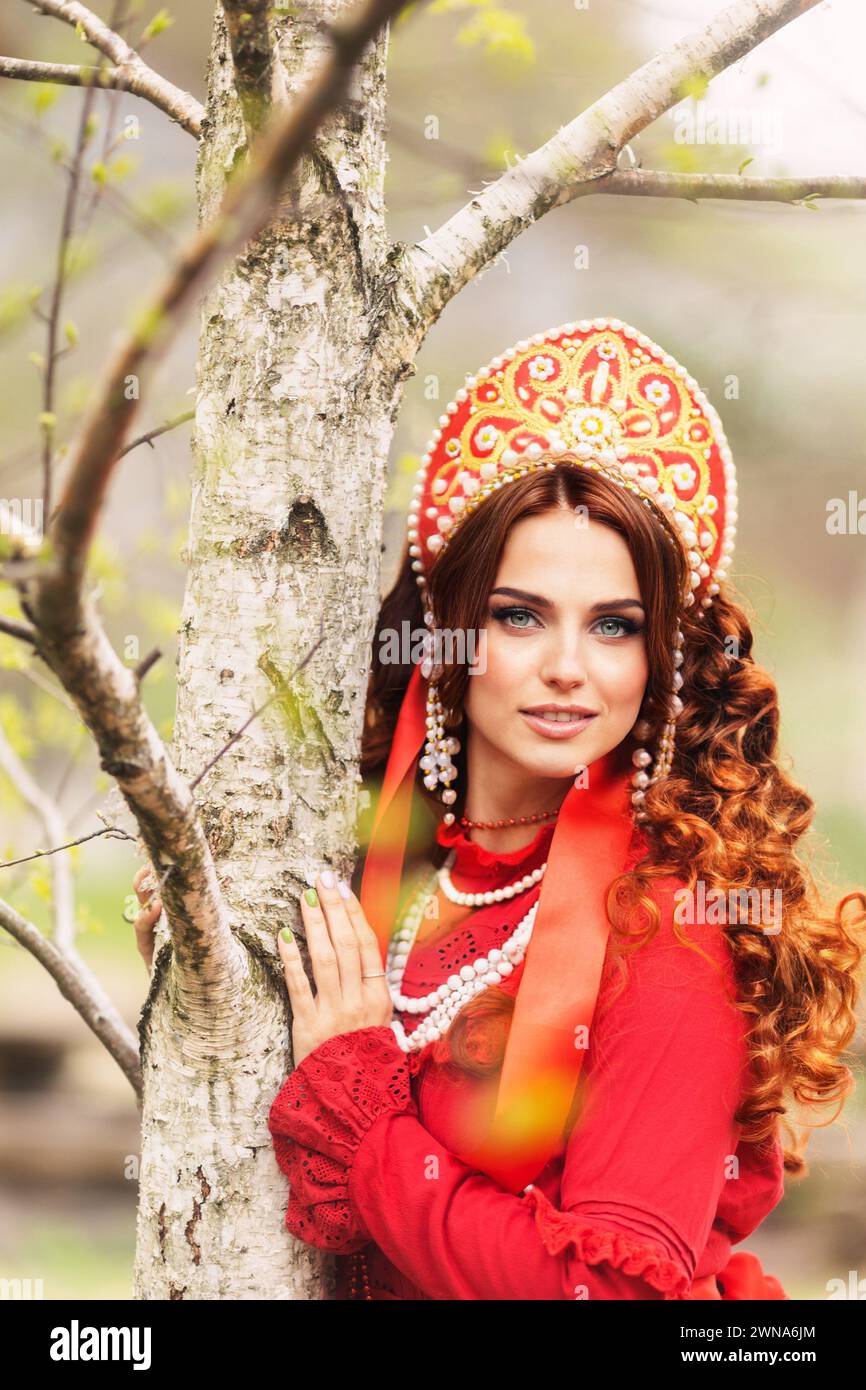 russian girl in traditional russian sarafan and kokoshnik embroidering ...