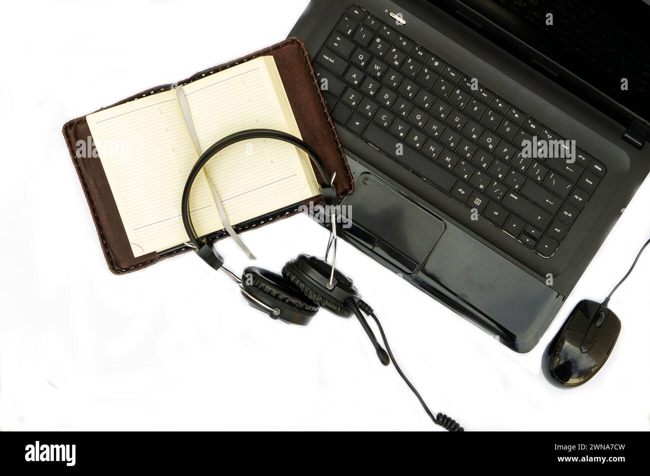 Modern workplace, accessories laptop, headphones, mouse, Notepad on a ...