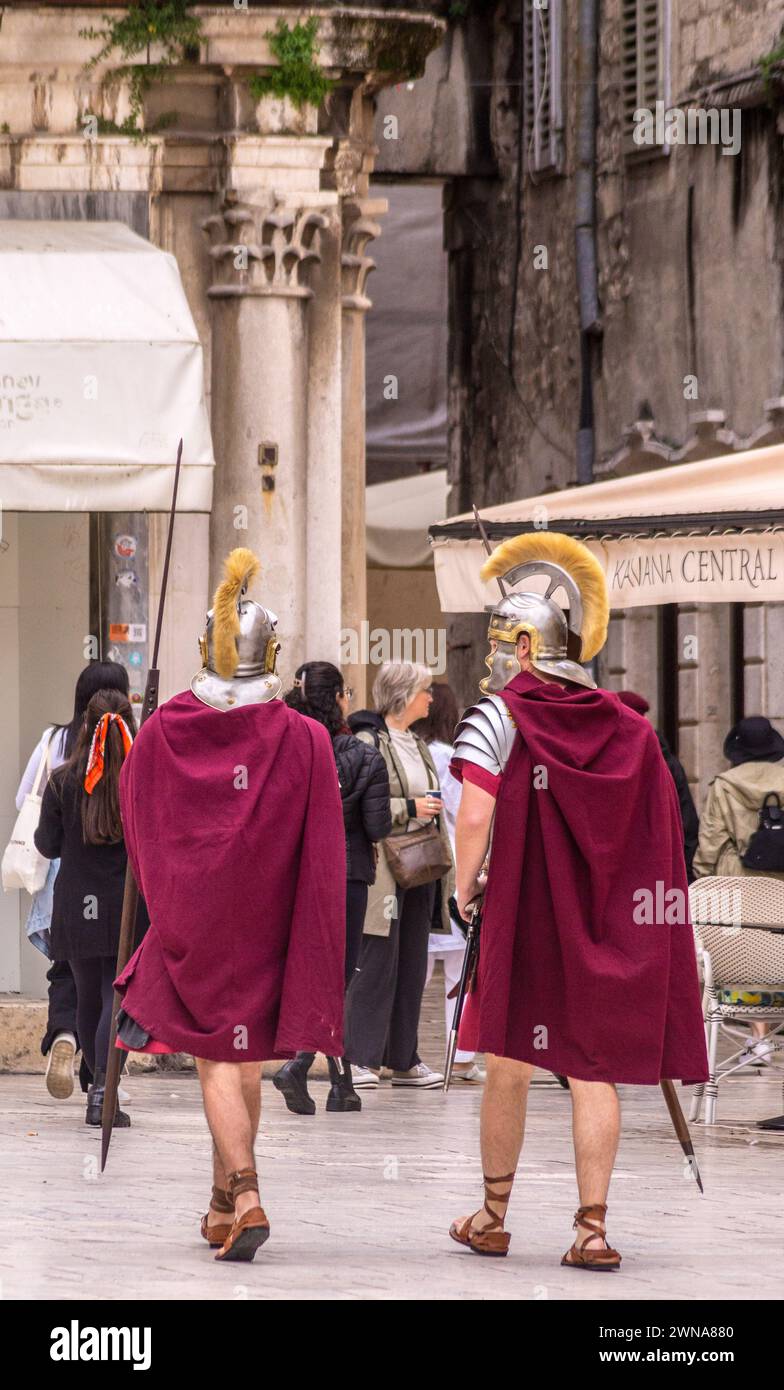 Actors in Roman soldiers' uniform posing with tourists for photographs ...
