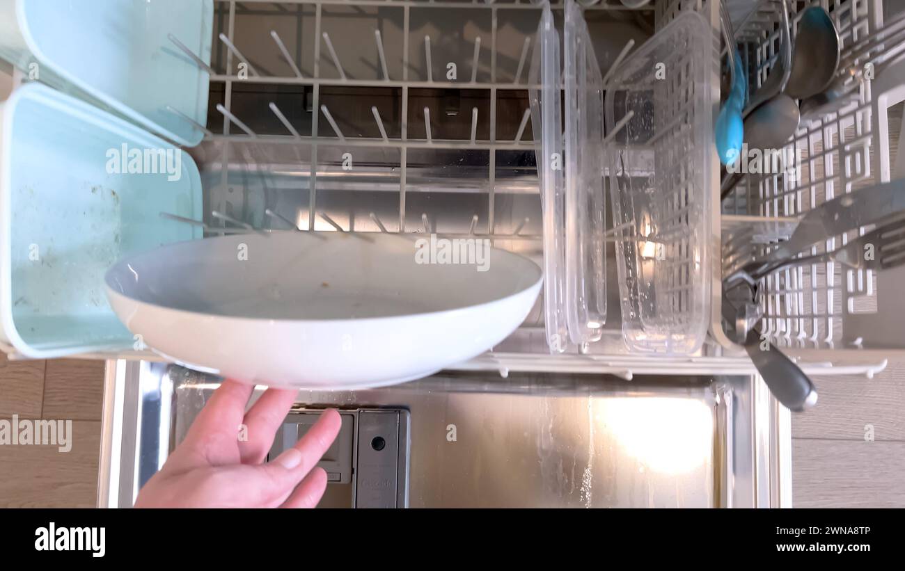 Household Chore of Loading Dirty Dishes into a Dishwasher Stock Photo ...