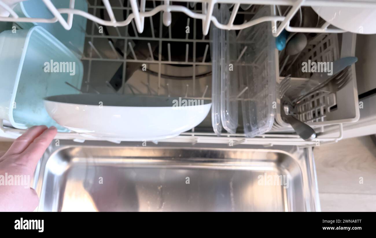 Household Chore of Loading Dirty Dishes into a Dishwasher Stock Photo ...