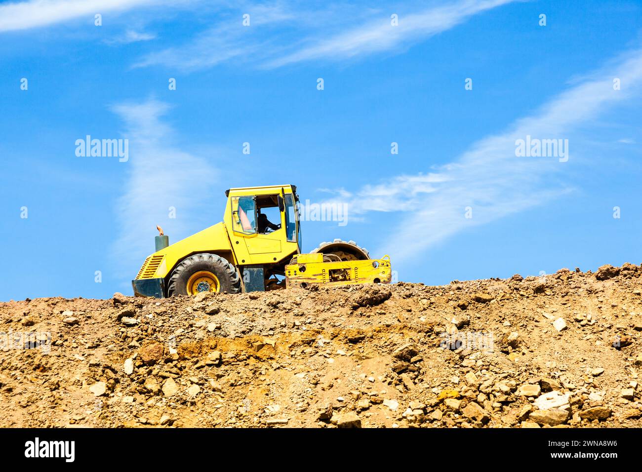 yellow compaction machine at the construction site for compacting the ...