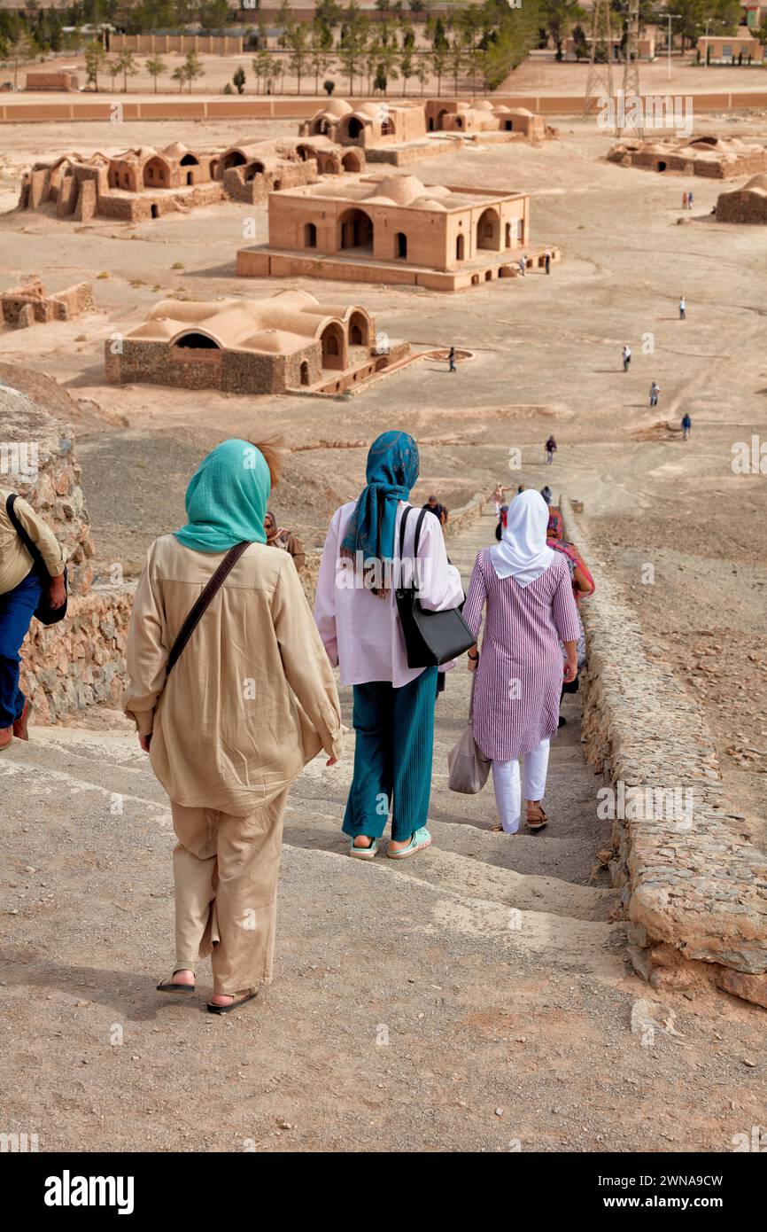 Tourists walk down a stone stair after visiting the Tower of Silence ...