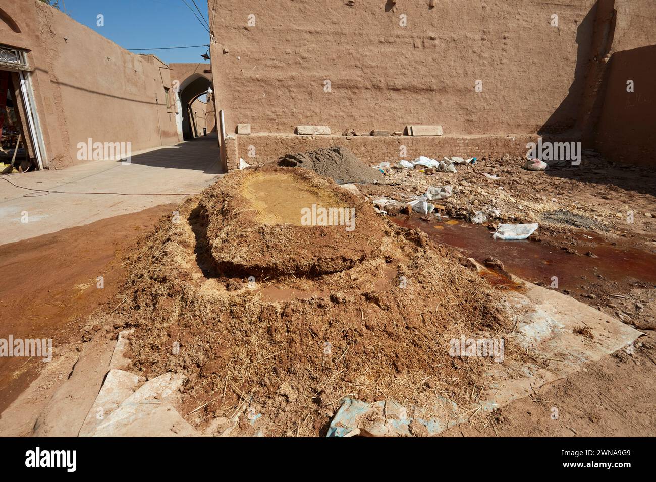 Raw adobe mixture (a composite of earth mixed with water, straw and ...