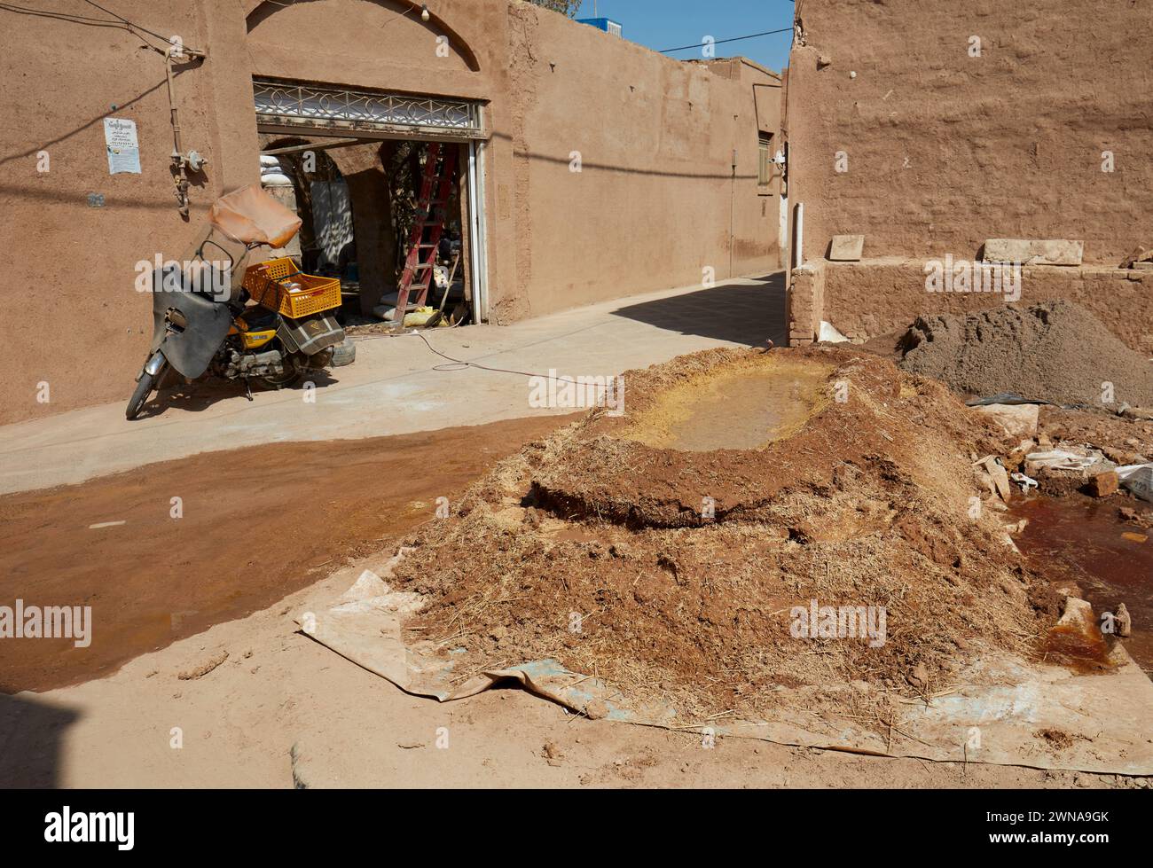 Raw adobe mixture (a composite of earth mixed with water, straw and ...