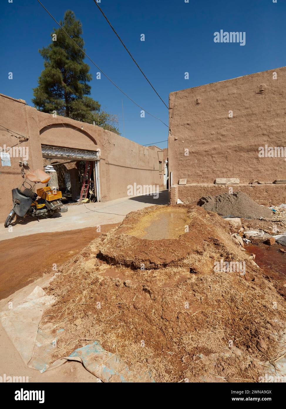 Raw adobe mixture (a composite of earth mixed with water, straw and ...