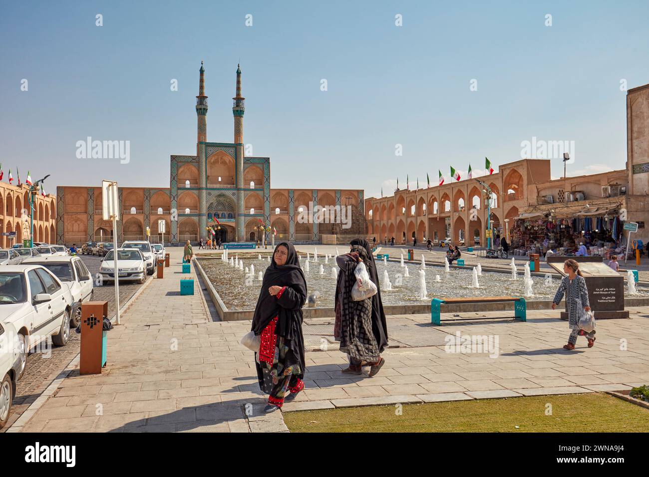 Local women in traditional chadors walk in the Amir Chakhmaq Square in ...