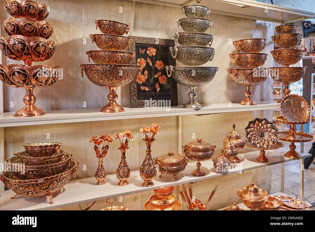 A selection of various handmade copper items displayed in a gift shop ...