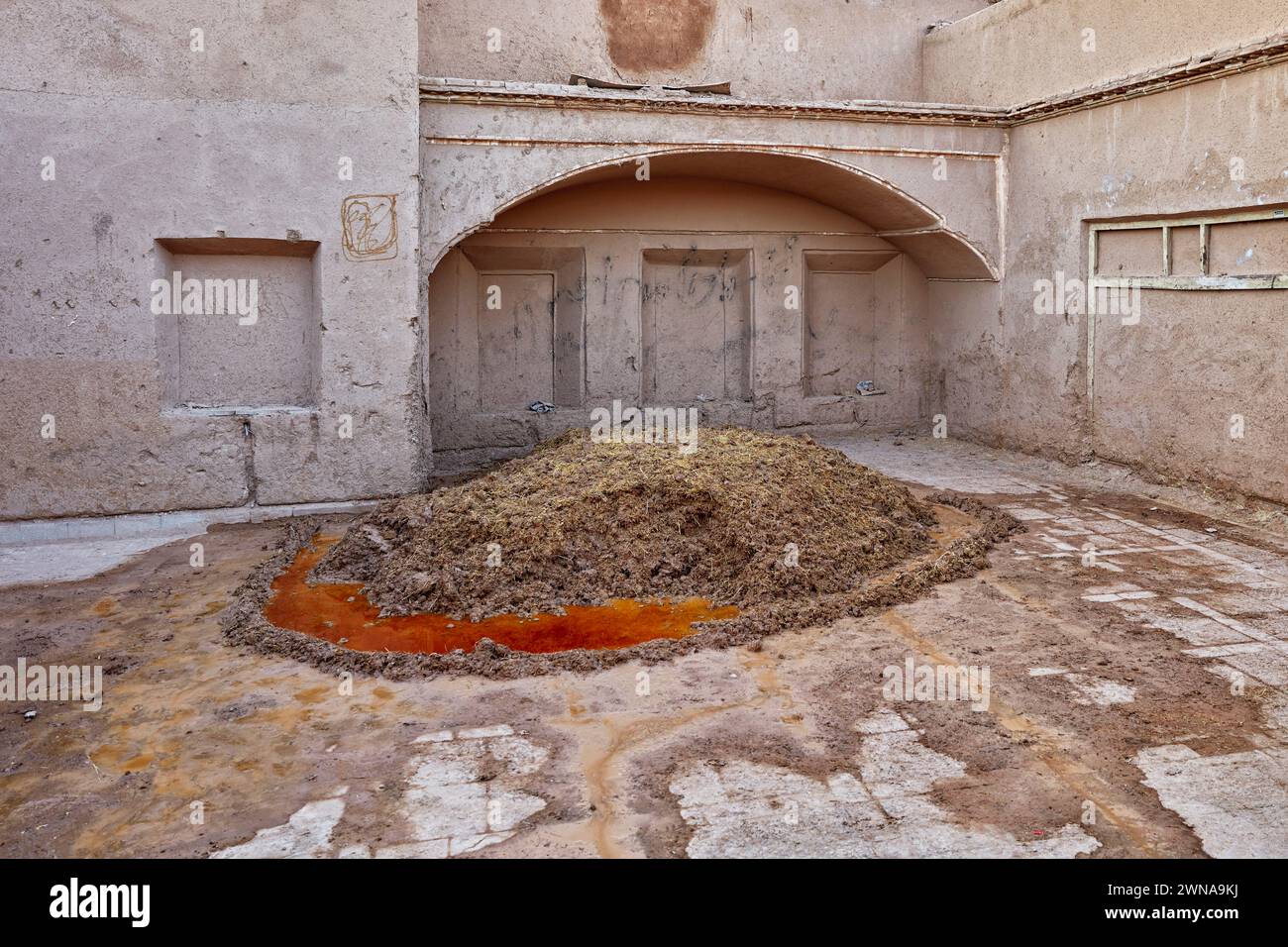 Raw adobe mixture (a composite of earth mixed with water, straw and ...
