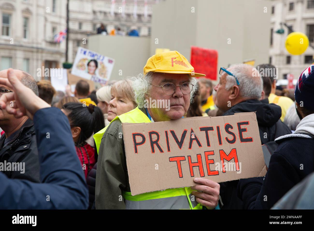 Anti-monarchy placards are held as people gather to view the coronation ...