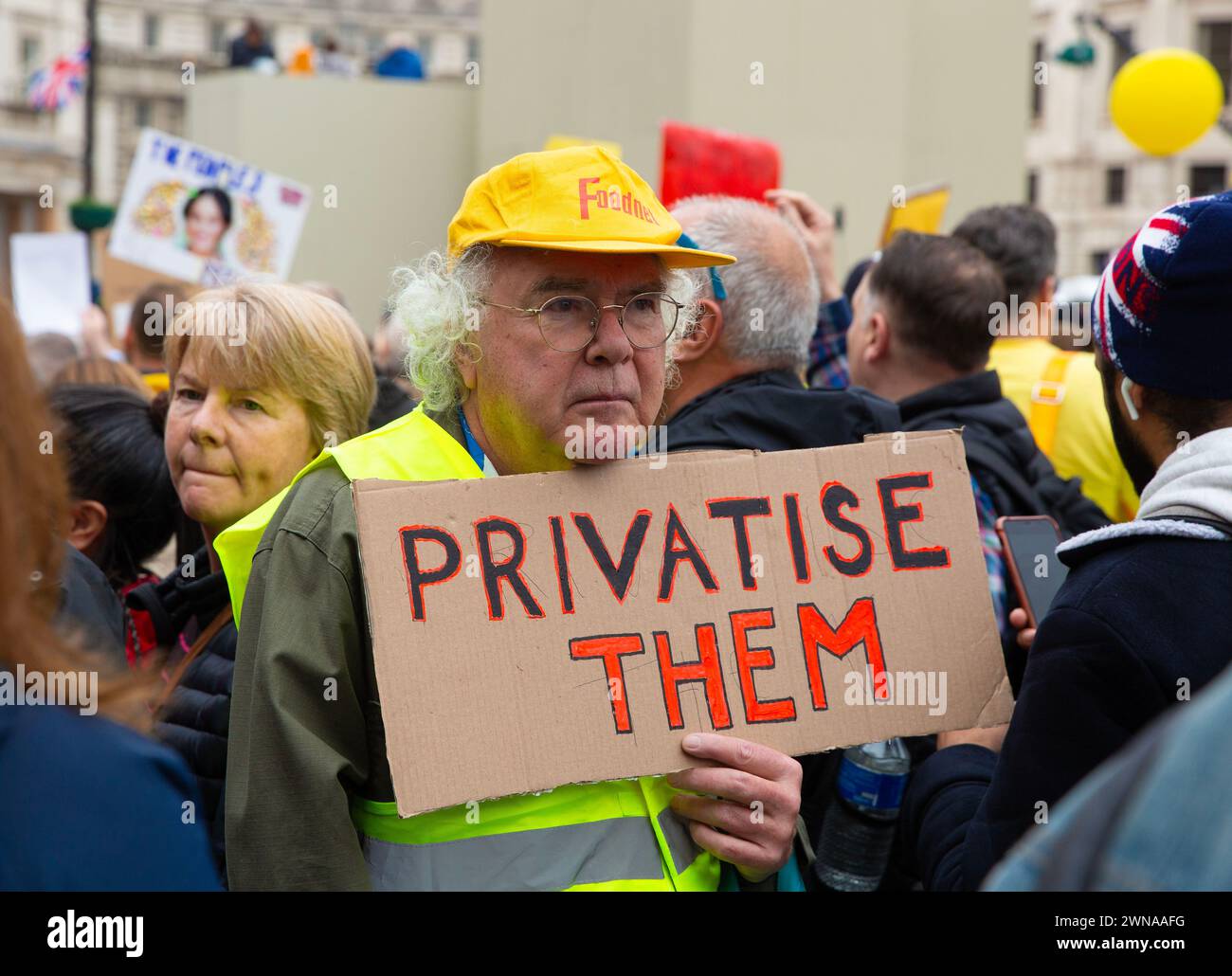 Anti-monarchy placards are held as people gather to view the coronation ...