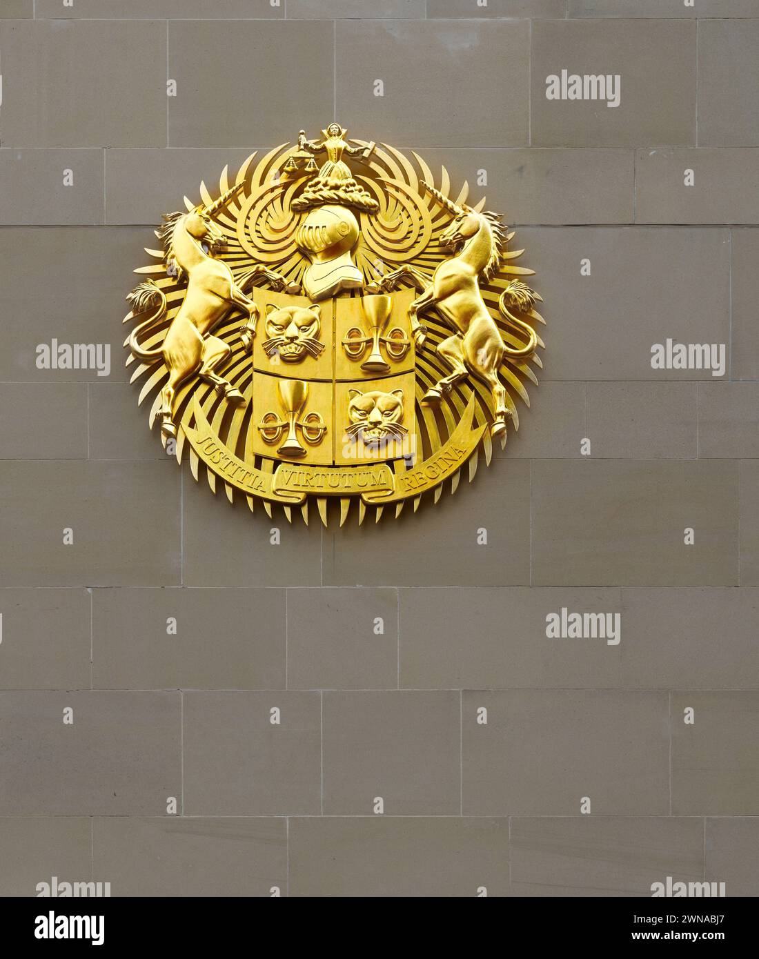 Golden emblem and motto of The Goldsmiths' Centre on their building in ...
