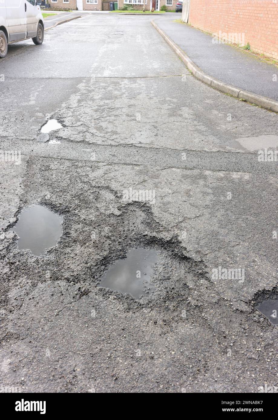 Potholes on an english road Stock Photo - Alamy