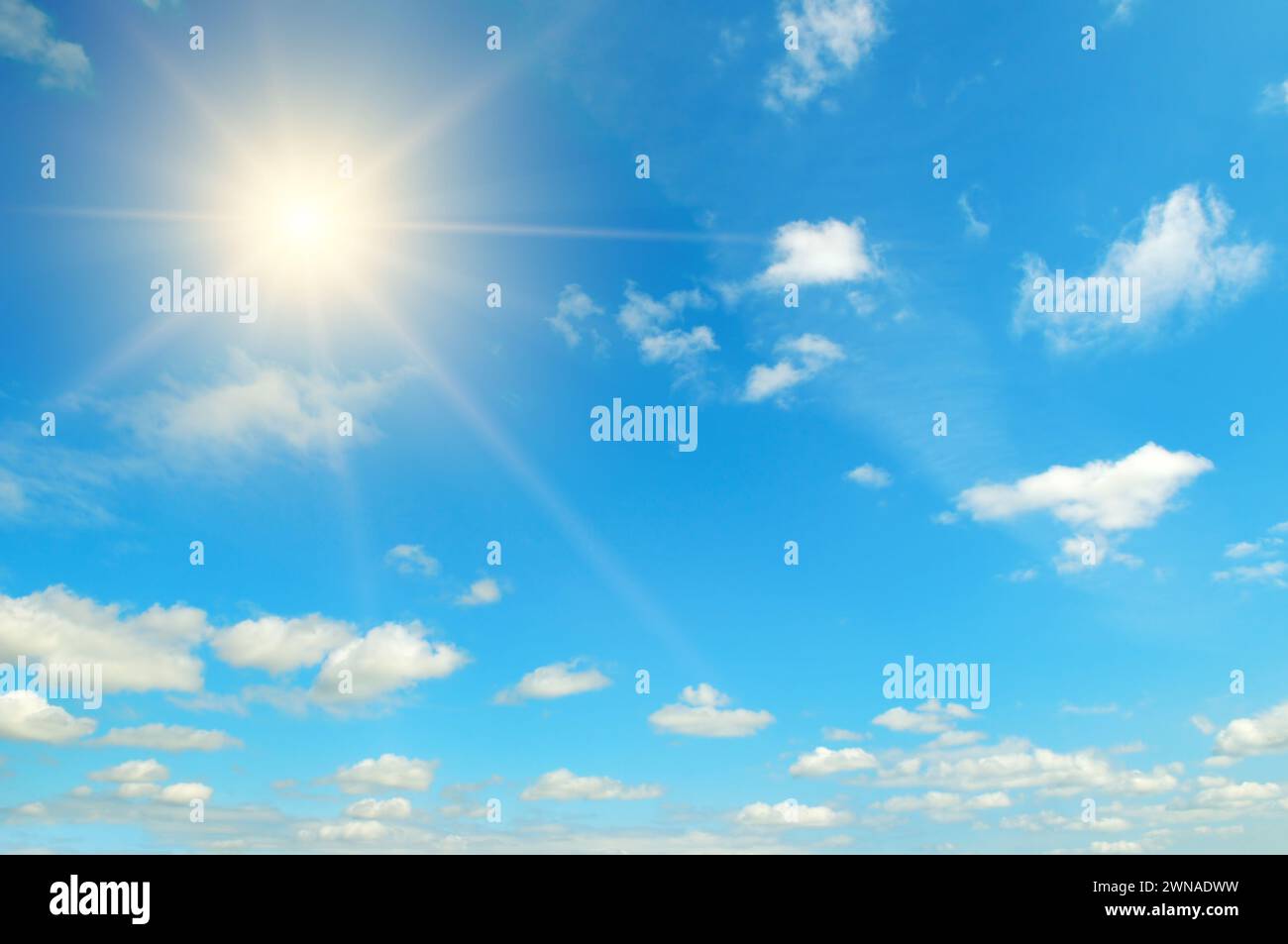 Couds in the blue sky. Bright midday sun illuminates the space Stock ...