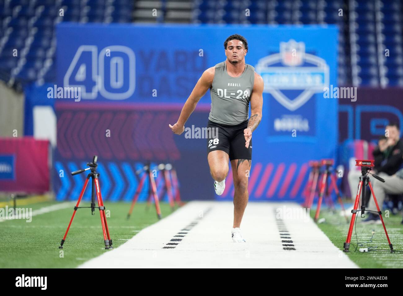 Kansas defensive lineman Austin Booker runs the 40-yard dash at the NFL ...