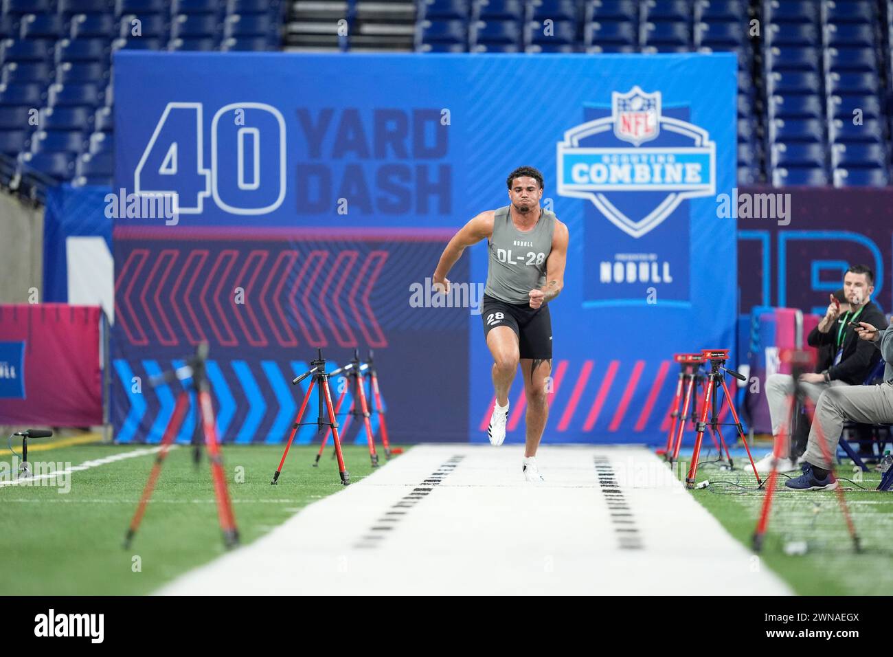 Kansas defensive lineman Austin Booker runs the 40-yard dash at the NFL ...