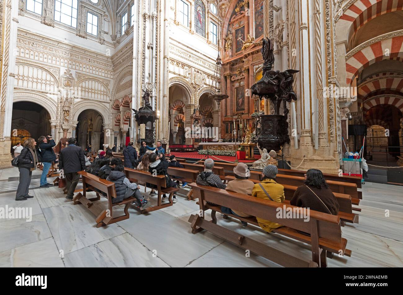 Mosque/ Cathedral of Cordoba Visitors admire the surrounding interior ...