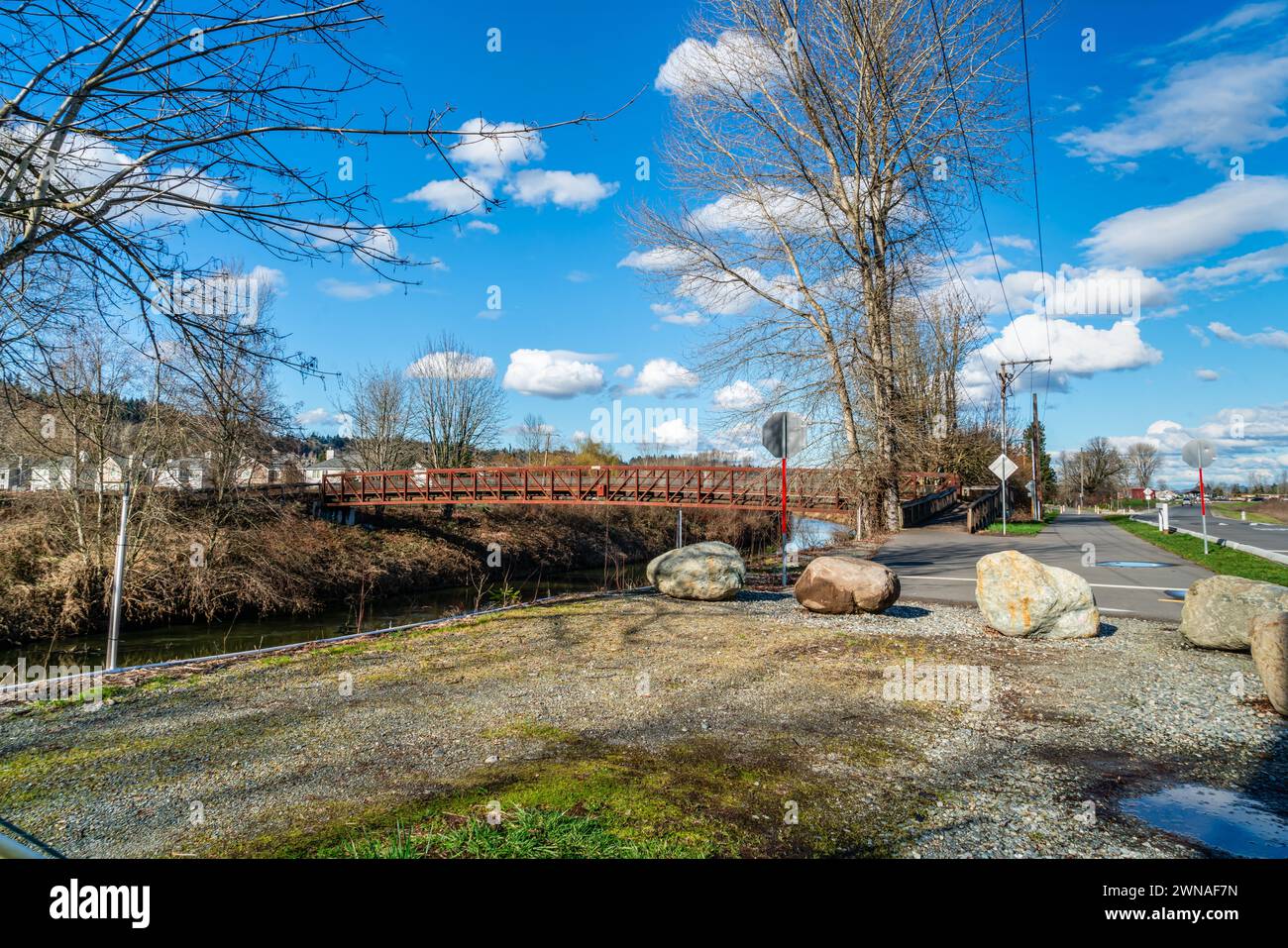 A rusty pedestrian bridge spans the Green River in Kent, Washington ...