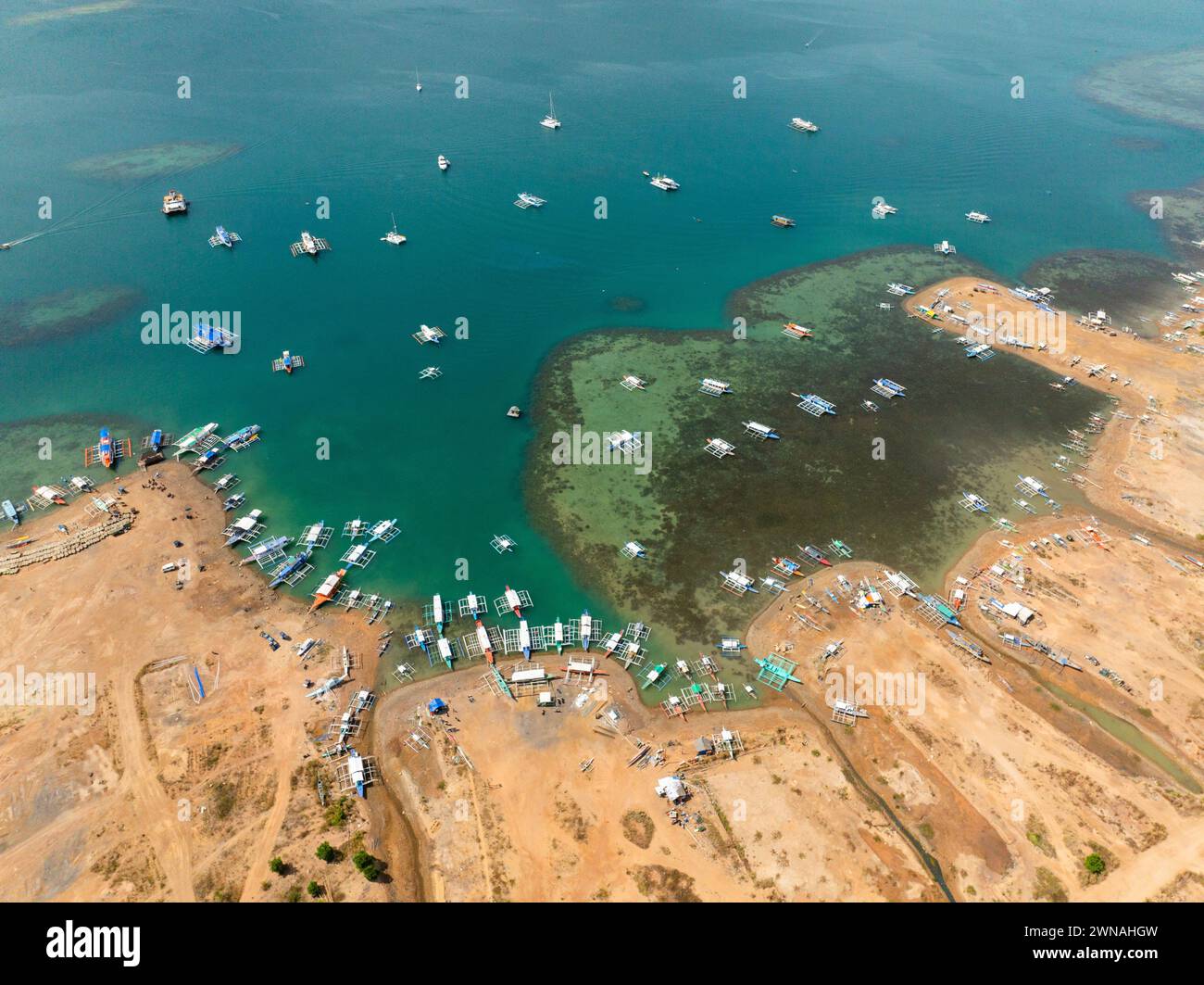 Top view of tourist boats floating over the turquoise sea water. Coron ...