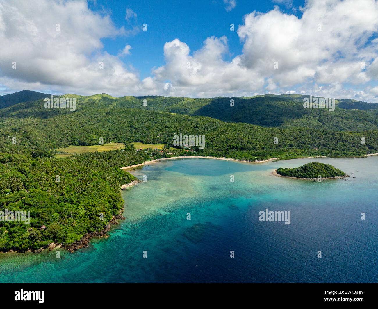 Island with beach and turquoise sea water. Blue sky and clouds. Romblon ...