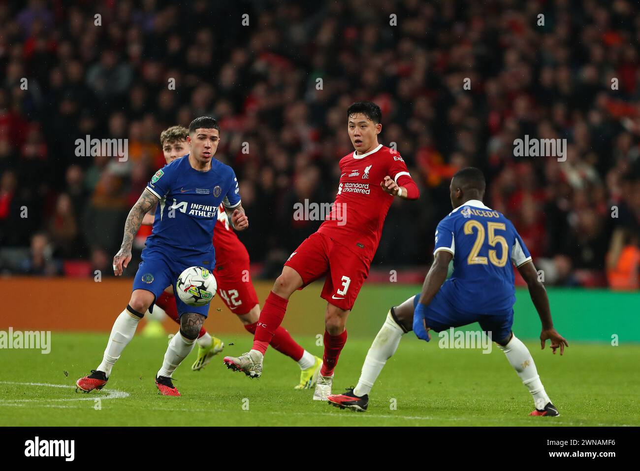 Wataru Endo of Liverpool in action with Enzo Fernandez (L) and Moises ...