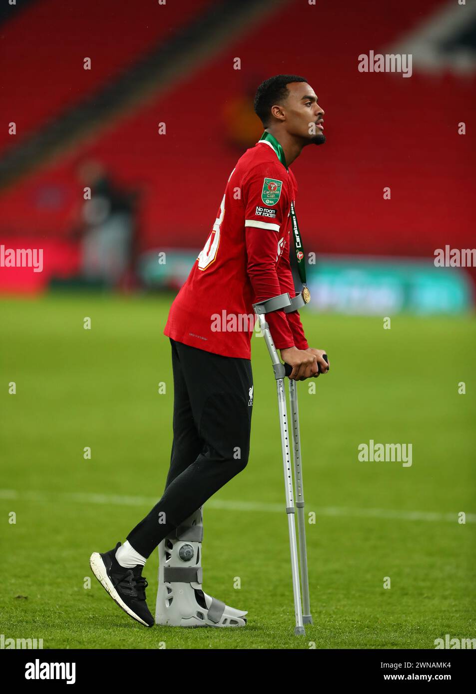Ryan Gravenberch of Liverpool seen with protective boot and crutches ...