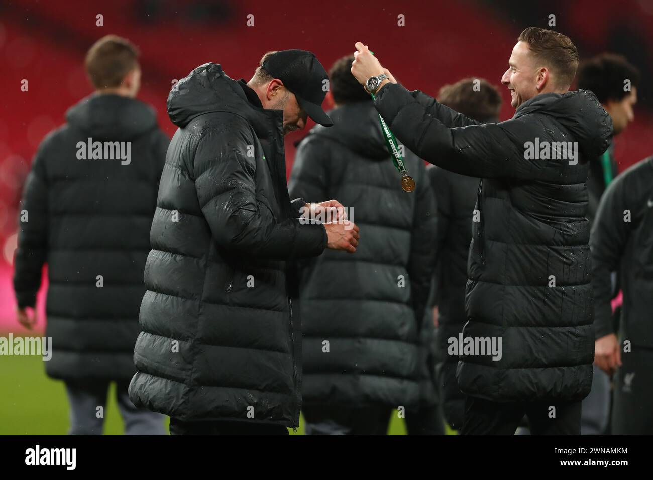 Assistant Manager of Liverpool Pep Lijnders places a winners medal over ...