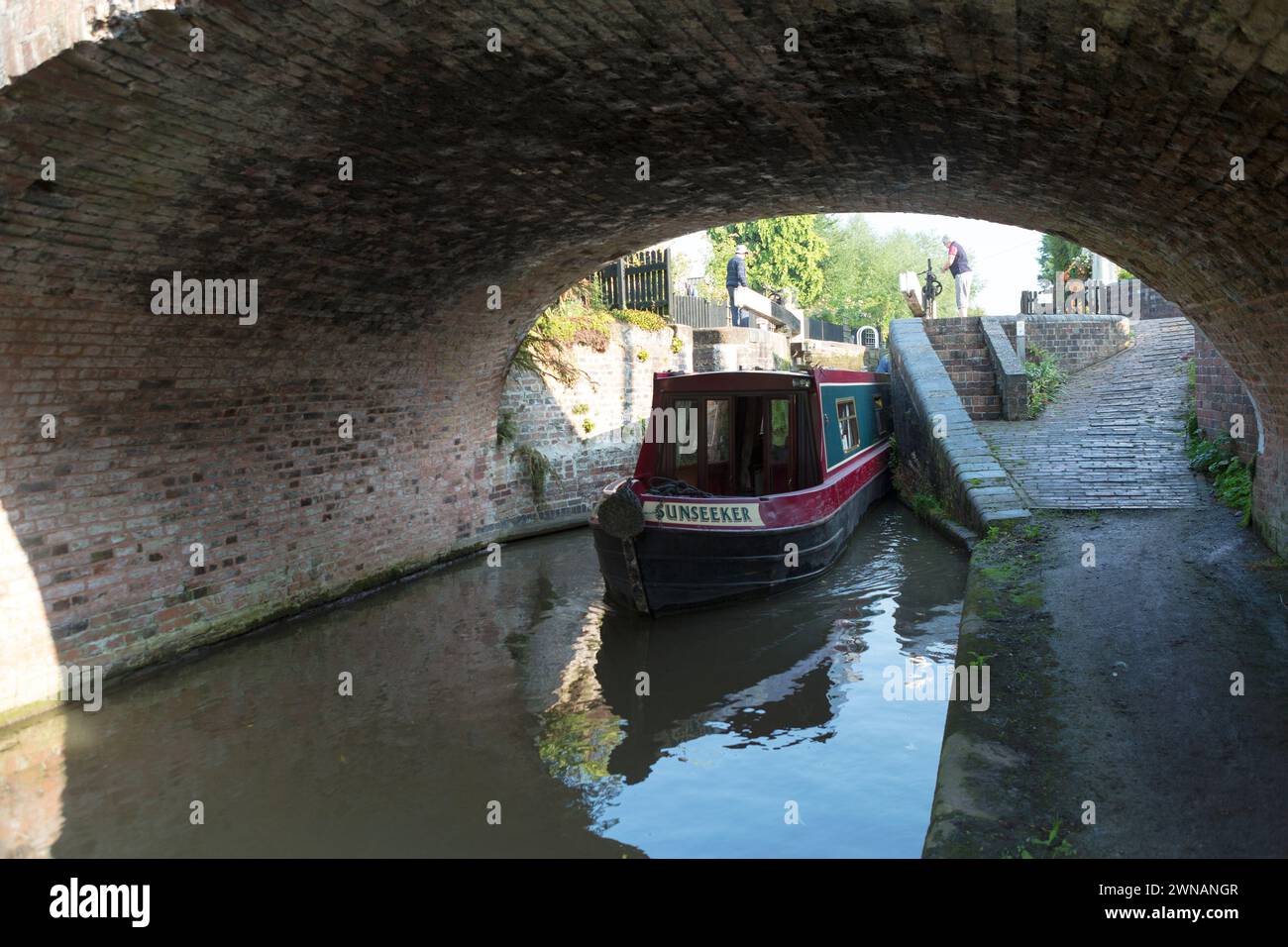Canal boat under road bridge on the Birmingham and Worcester Canal ...