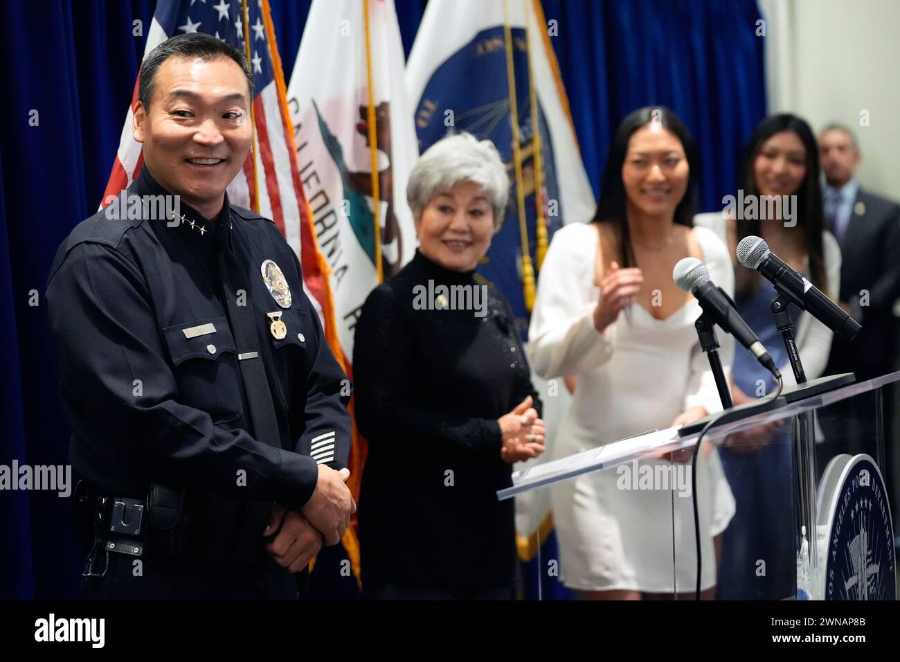 The mother and daughters of Chief Dominic H. Choi, look on after he is ...