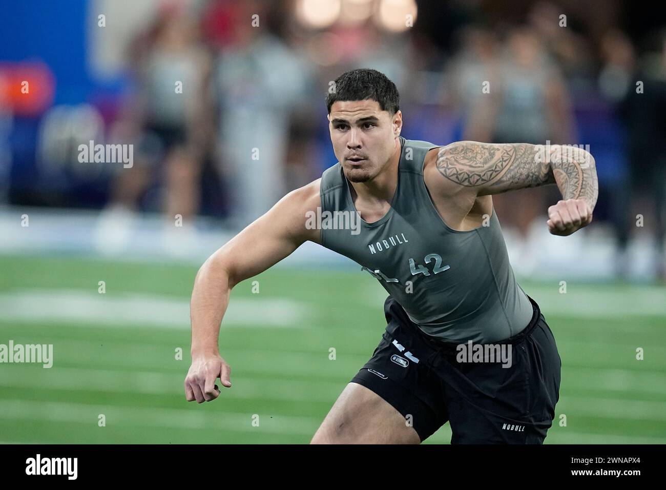 UCLA defensive lineman Laiatu Latu runs a drill at the NFL football ...