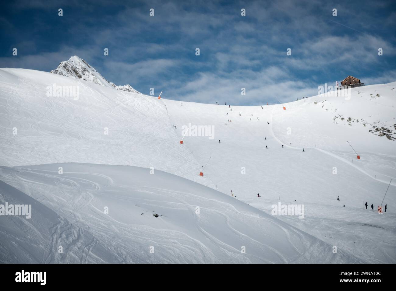 Ski resort in winter Alps. Skiers ride down the slope. Tux, Hintertux ...