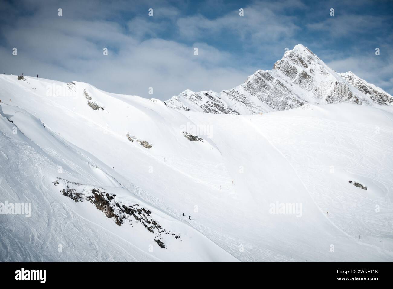 Ski resort in winter Alps. Skiers ride down the slope. Tux, Hintertux ...