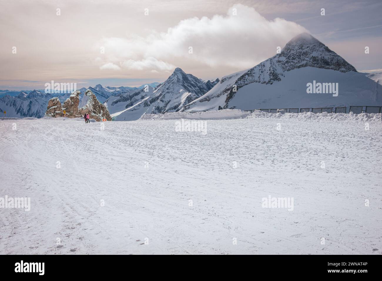 Alpine landscape with peaks covered by snow and clouds, beautiful ...
