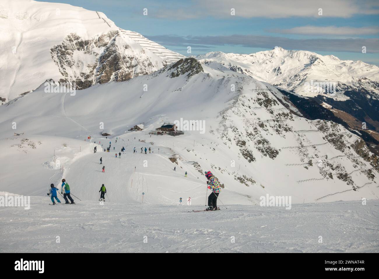 Ski resort in winter Alps. Skiers ride down the slope. Tux, Hintertux ...