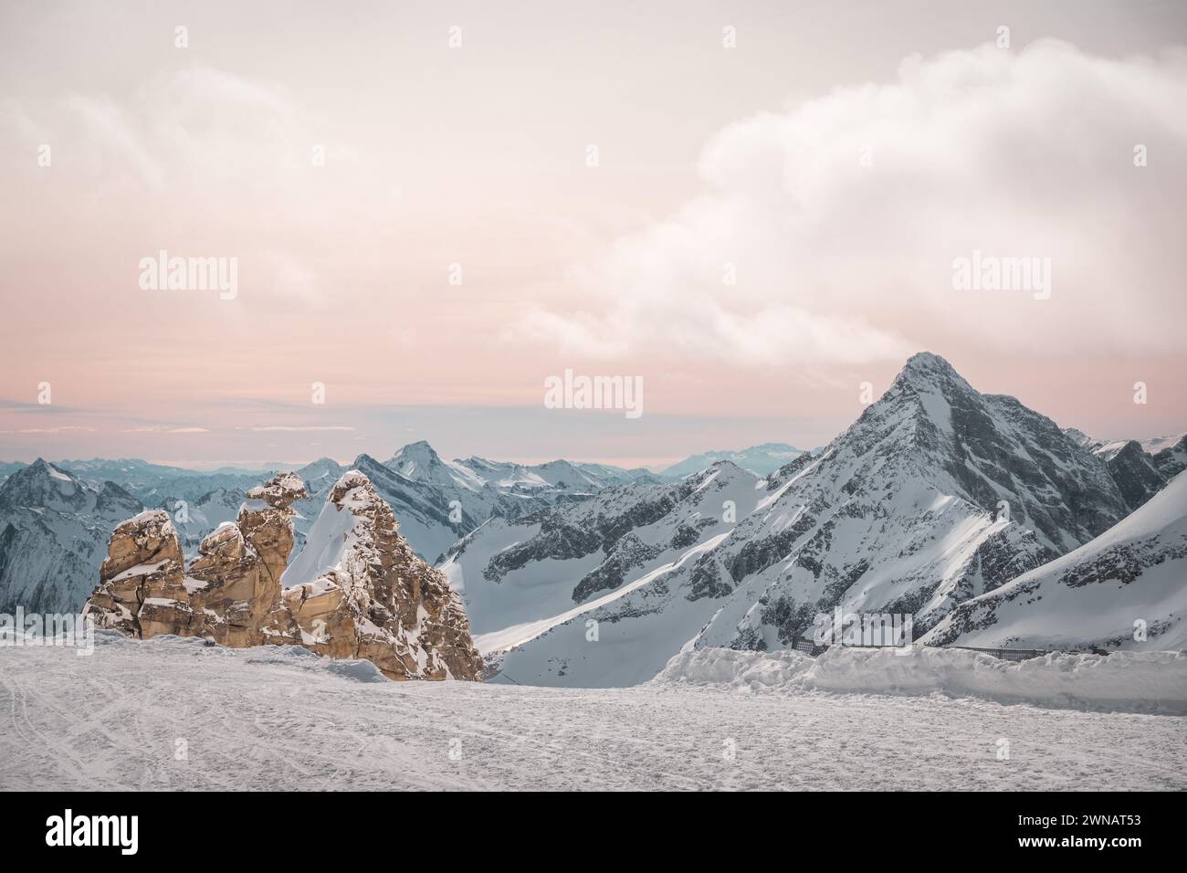 Alpine landscape with peaks covered by snow and clouds, beautiful ...