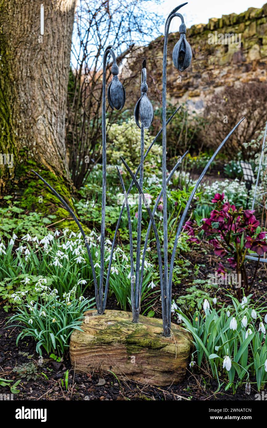Snowdrops and ornamental feature, Shepherd House garden, Inveresk, East ...