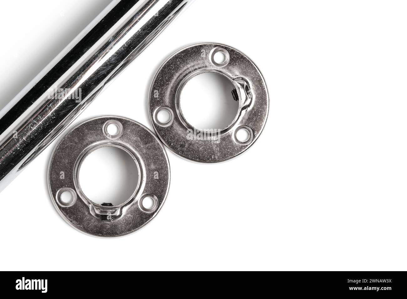 Nickel plated tube and two flanges for its attachment, white background ...