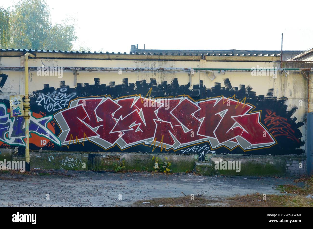 The old wall decorated with paint stains in the style of street art ...