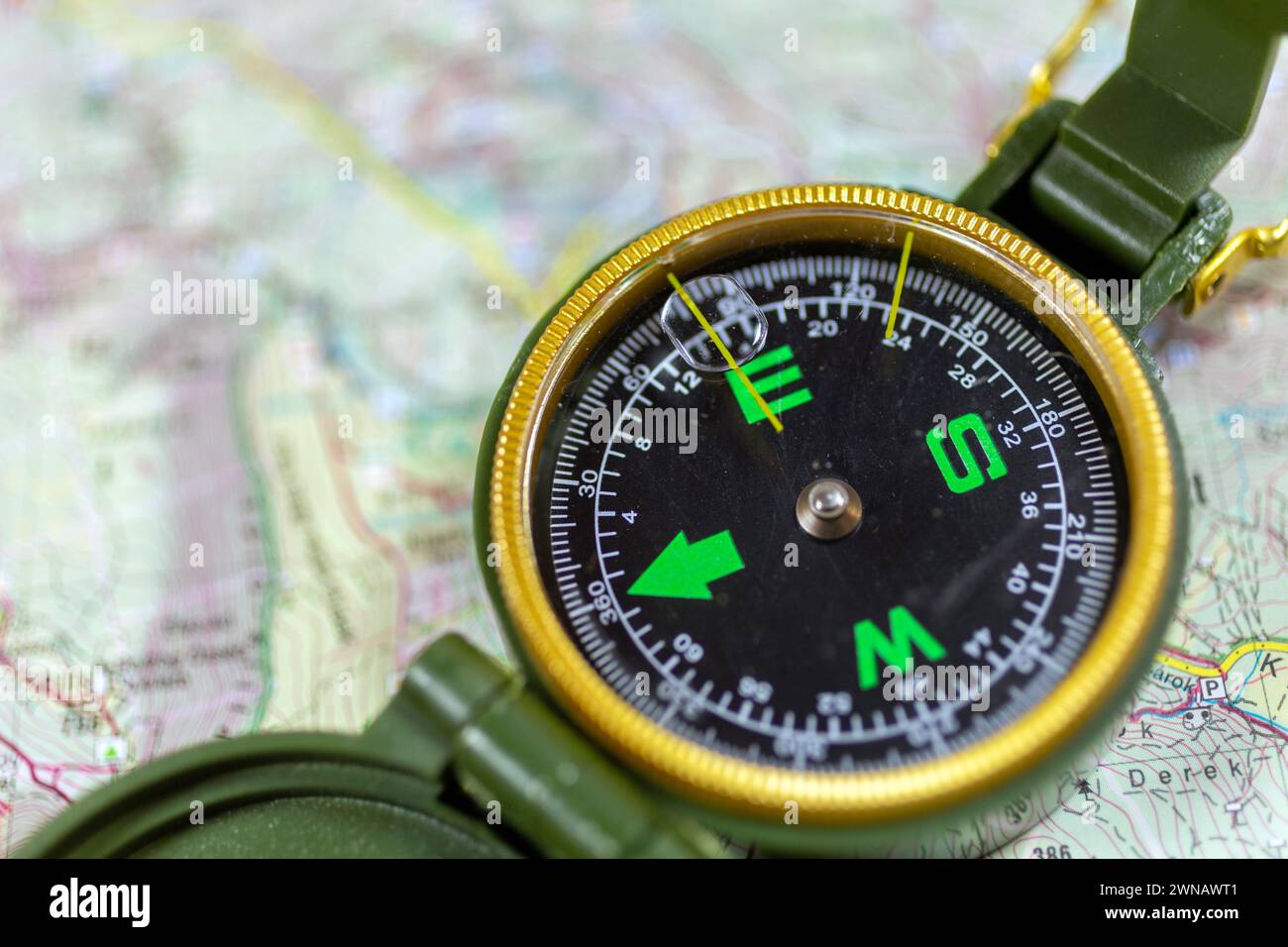 Analog compass on a paper map Stock Photo - Alamy