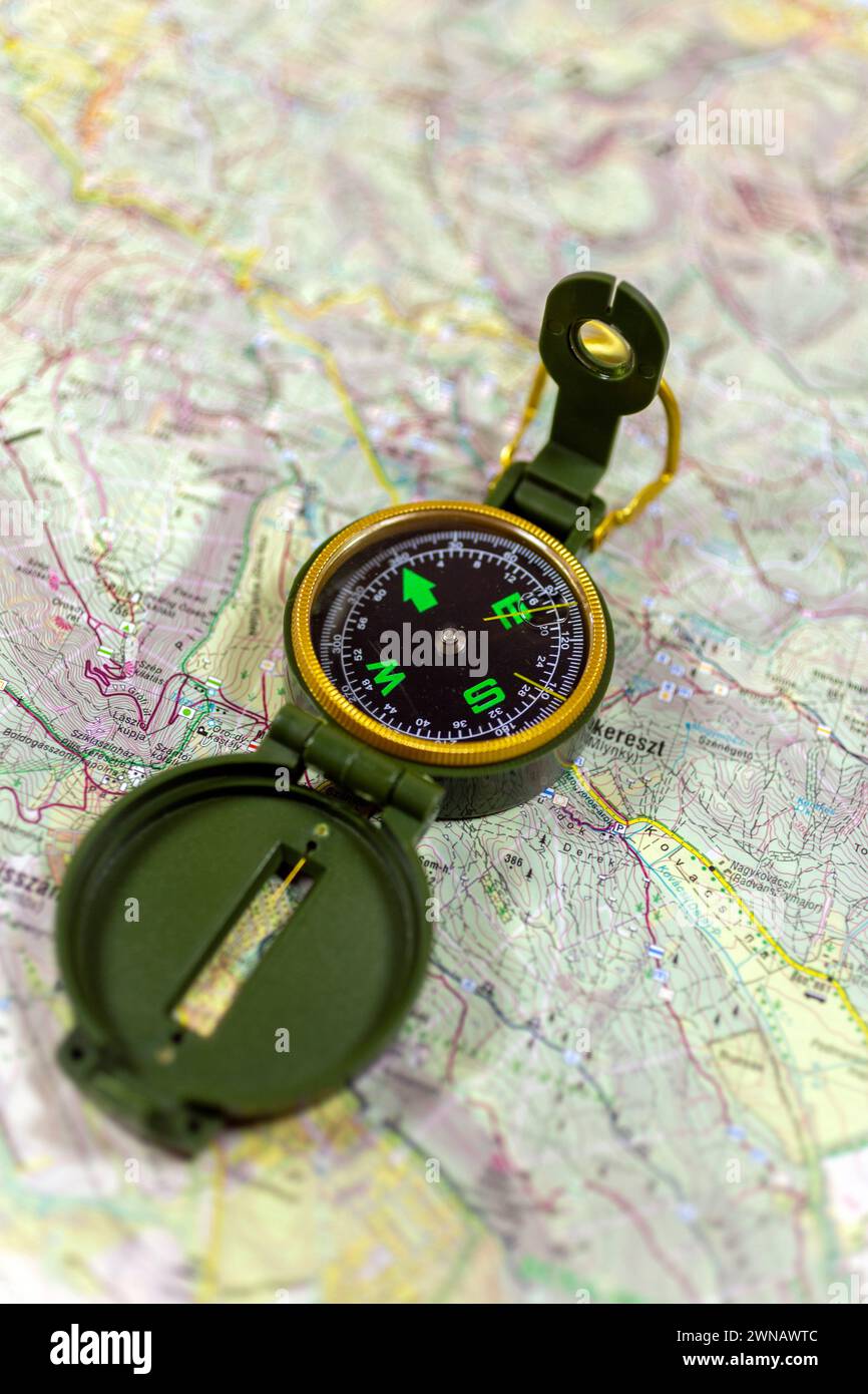 Analog compass on a paper map Stock Photo - Alamy
