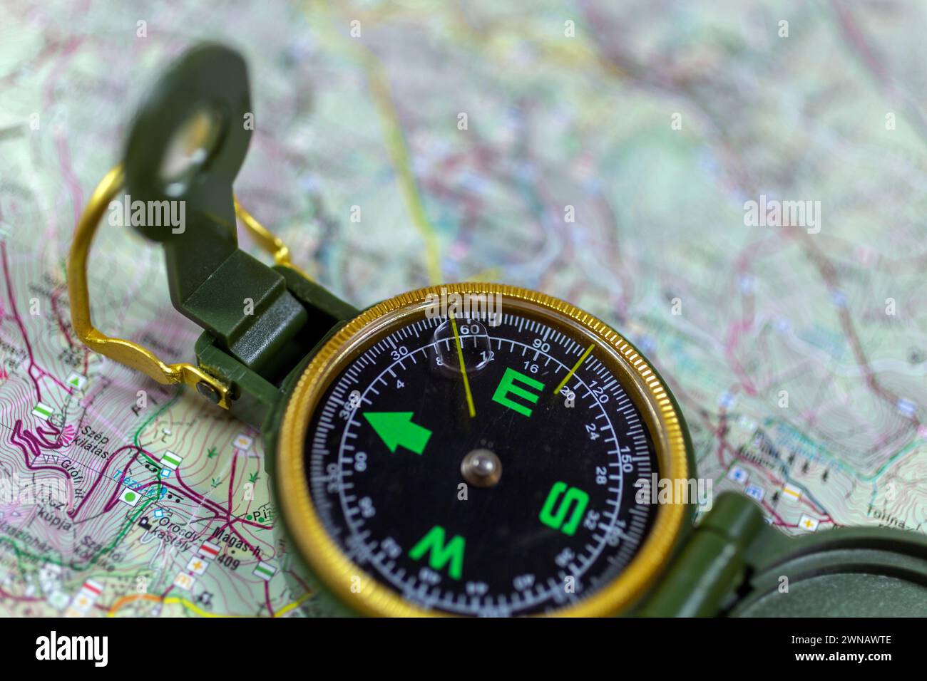 Analog compass on a paper map Stock Photo - Alamy