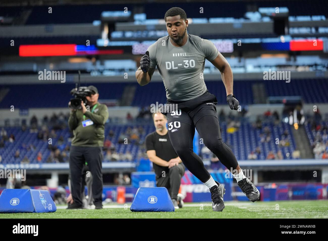Houston defensive lineman Nelson Ceaser runs a drill at the NFL ...