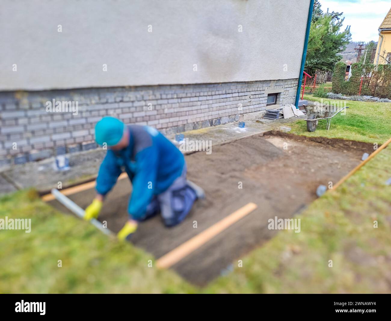 Laying gray concrete paving slabs in house courtyard driveway ...