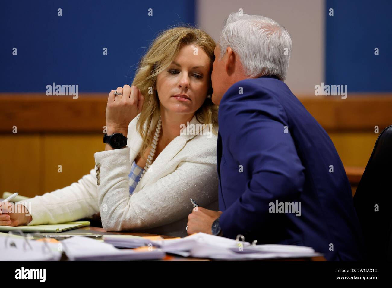 Attorney John Merchant speaks to his wife and co-counsel Ashleigh ...