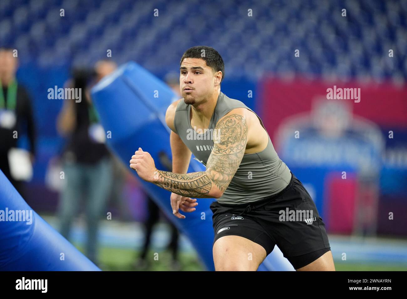 UCLA defensive lineman Laiatu Latu runs a drill at the NFL football ...