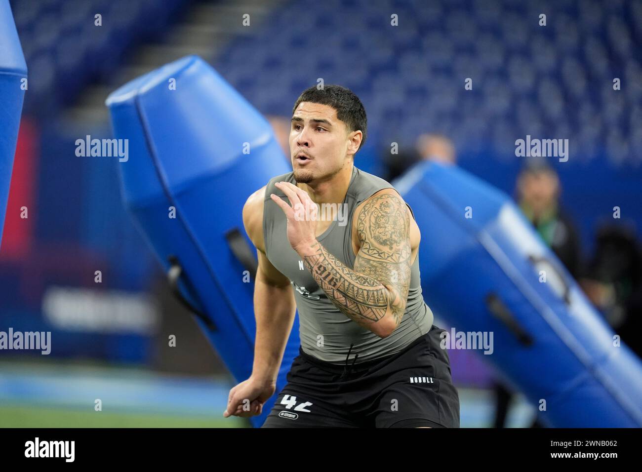 UCLA defensive lineman Laiatu Latu runs a drill at the NFL football ...