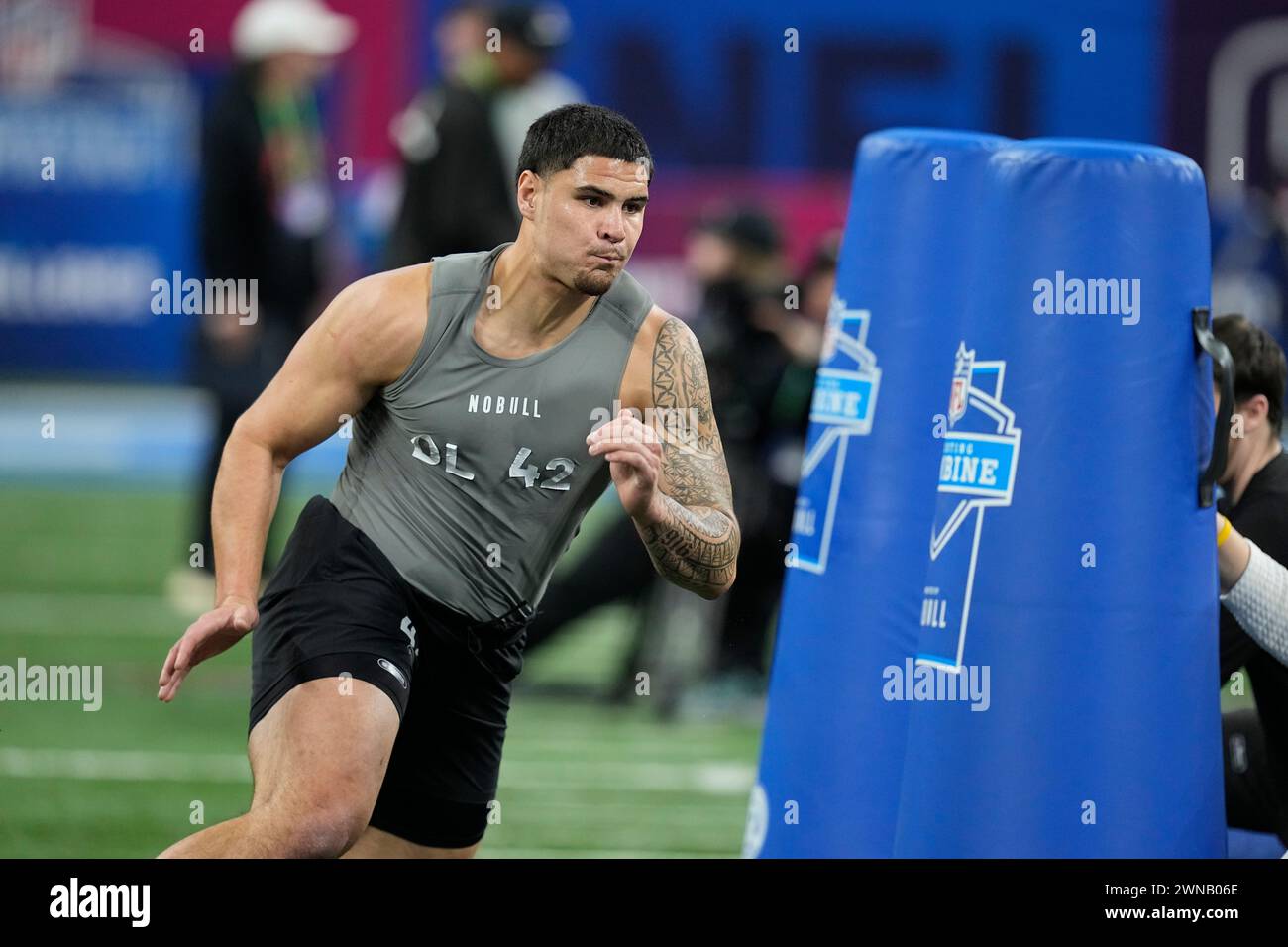 UCLA defensive lineman Laiatu Latu runs a drill at the NFL football ...