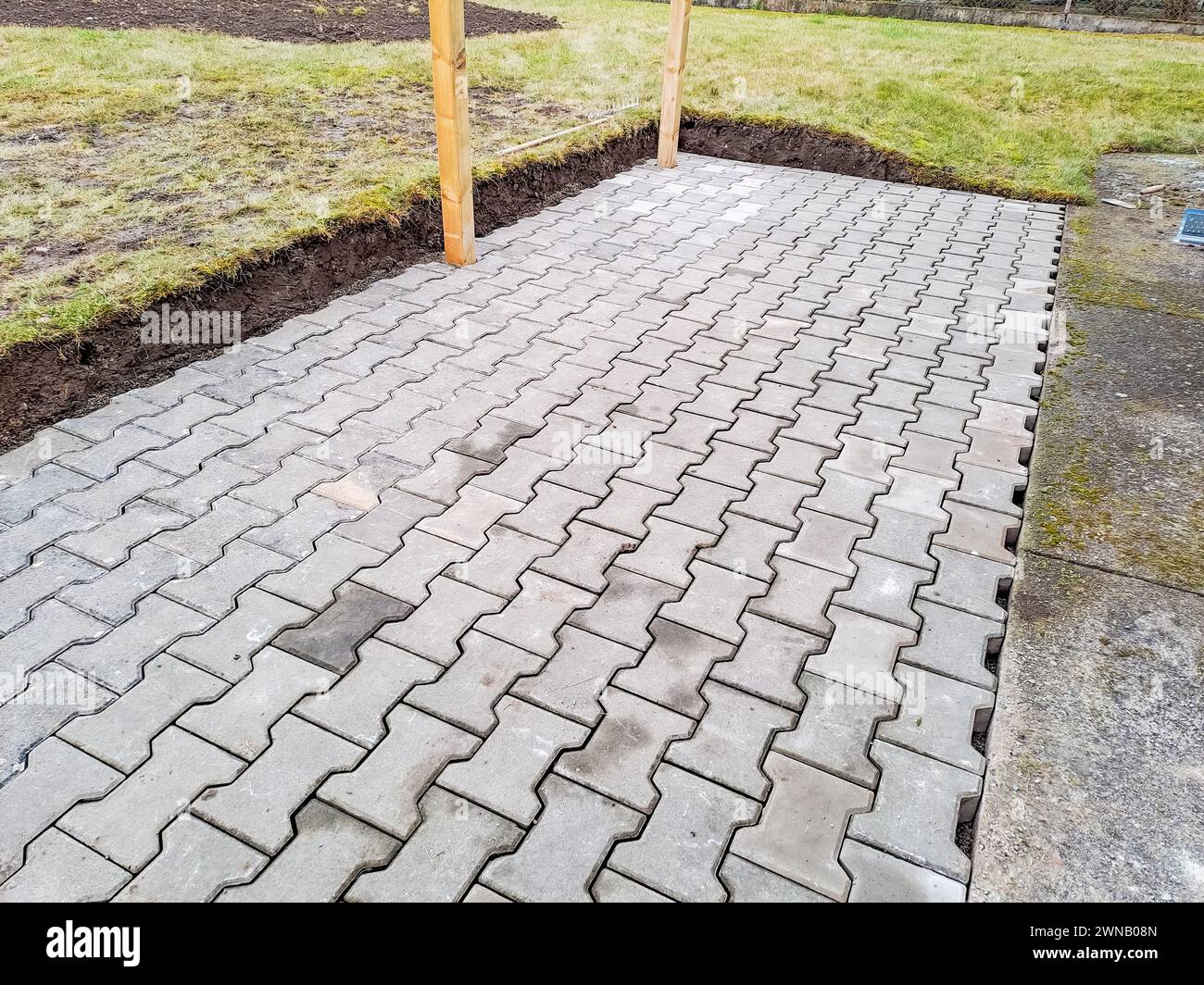 Laying gray concrete paving slabs in house courtyard driveway ...