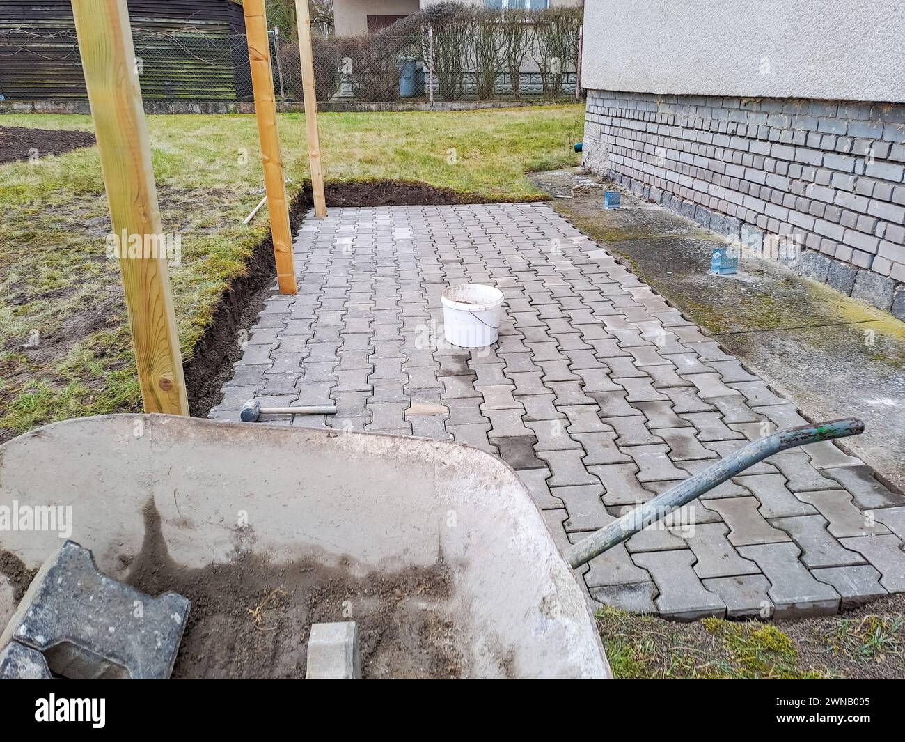 Laying gray concrete paving slabs in house courtyard driveway ...