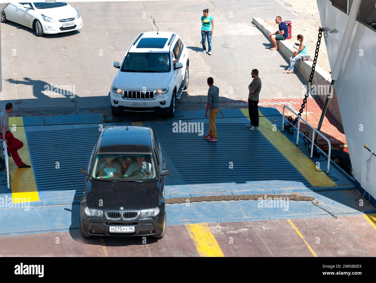 June 27, 2015 Russia Port Kavkaz. Loading cars onto a ferry on a summer ...